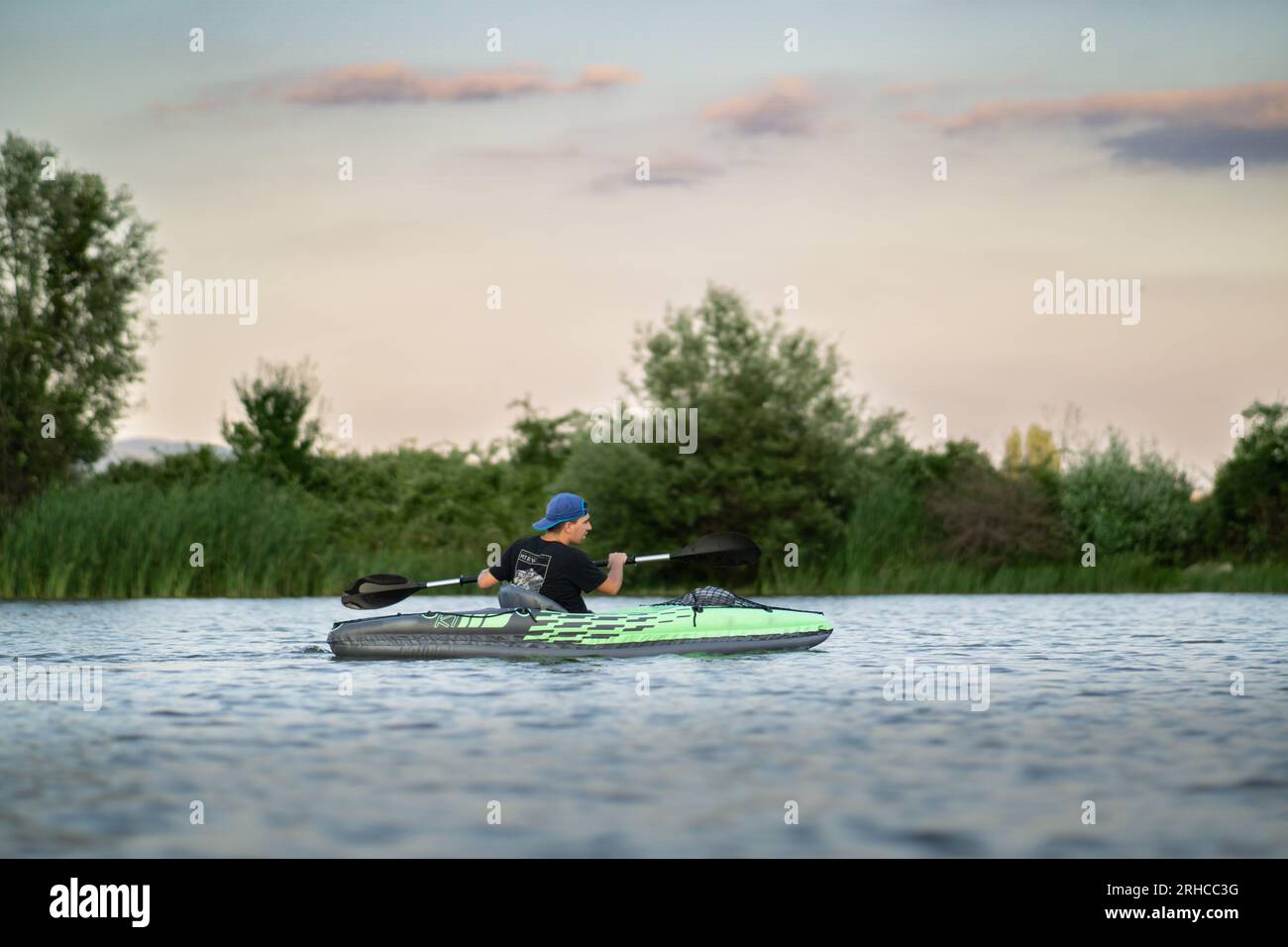 Professional photo of a young man kayaking in an inflatable kayak in a ...