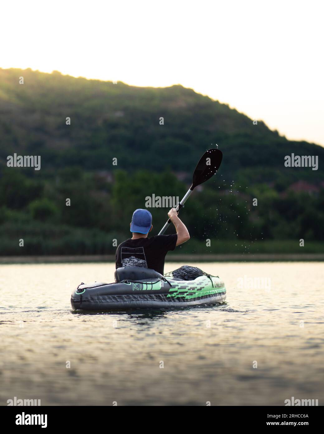 Professional photo of a young man kayaking in an inflatable kayak in a ...