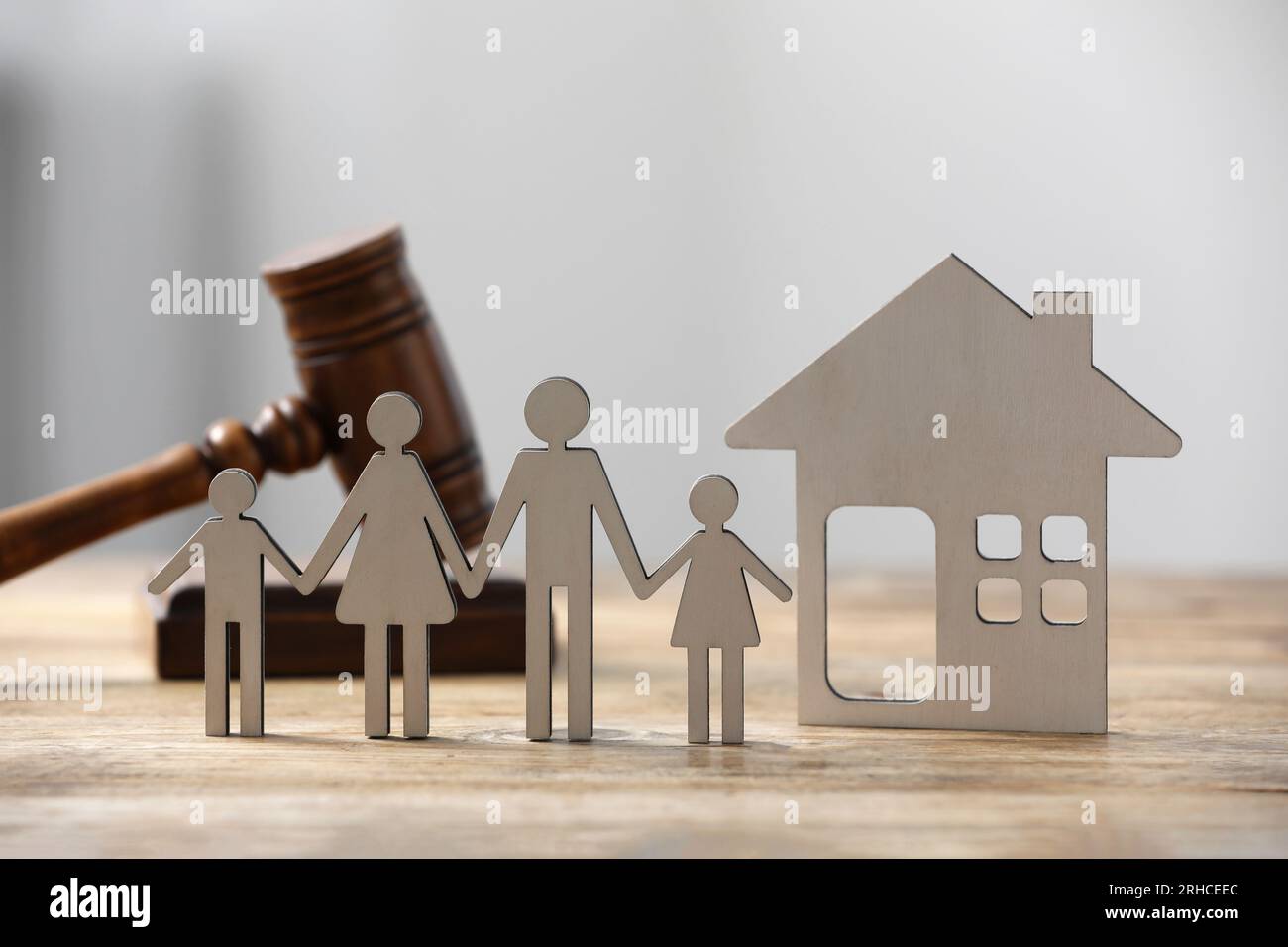 Family law. Figure of parents with children, house model and gavel on ...