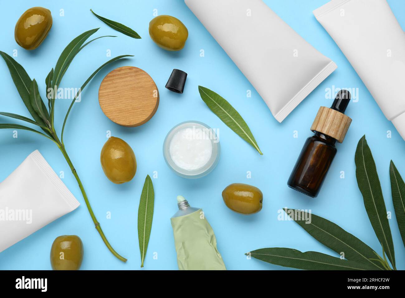 Cosmetic products with olive essential oil light turquoise background ...