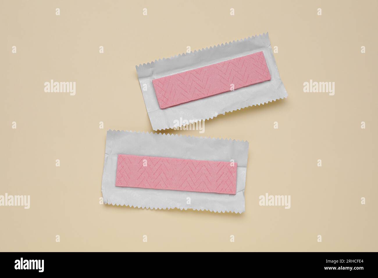 Unwrapped sticks of tasty chewing gum on beige background, flat lay ...