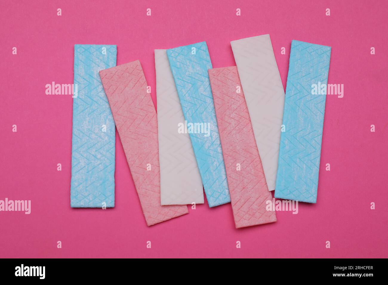 Sticks of tasty chewing gum on bright pink background, flat lay Stock ...