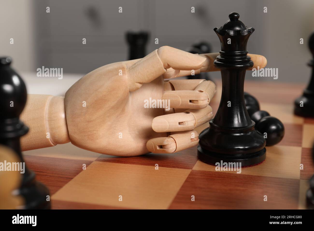 Robot moving chess piece on board, closeup. Wooden hand representing ...