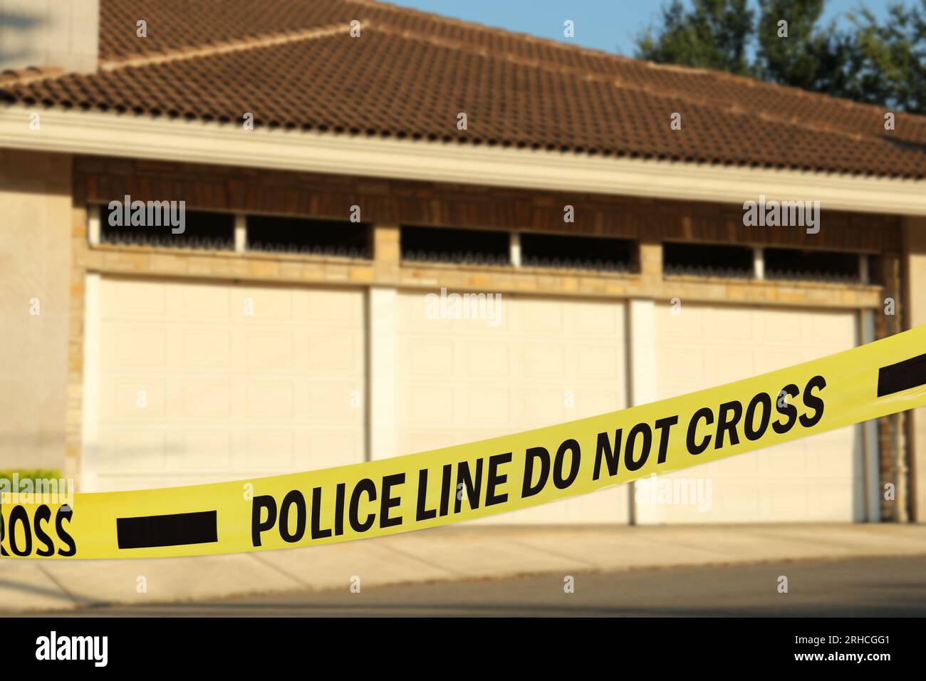 Yellow crime scene tape blocking way to garage outdoors Stock Photo - Alamy