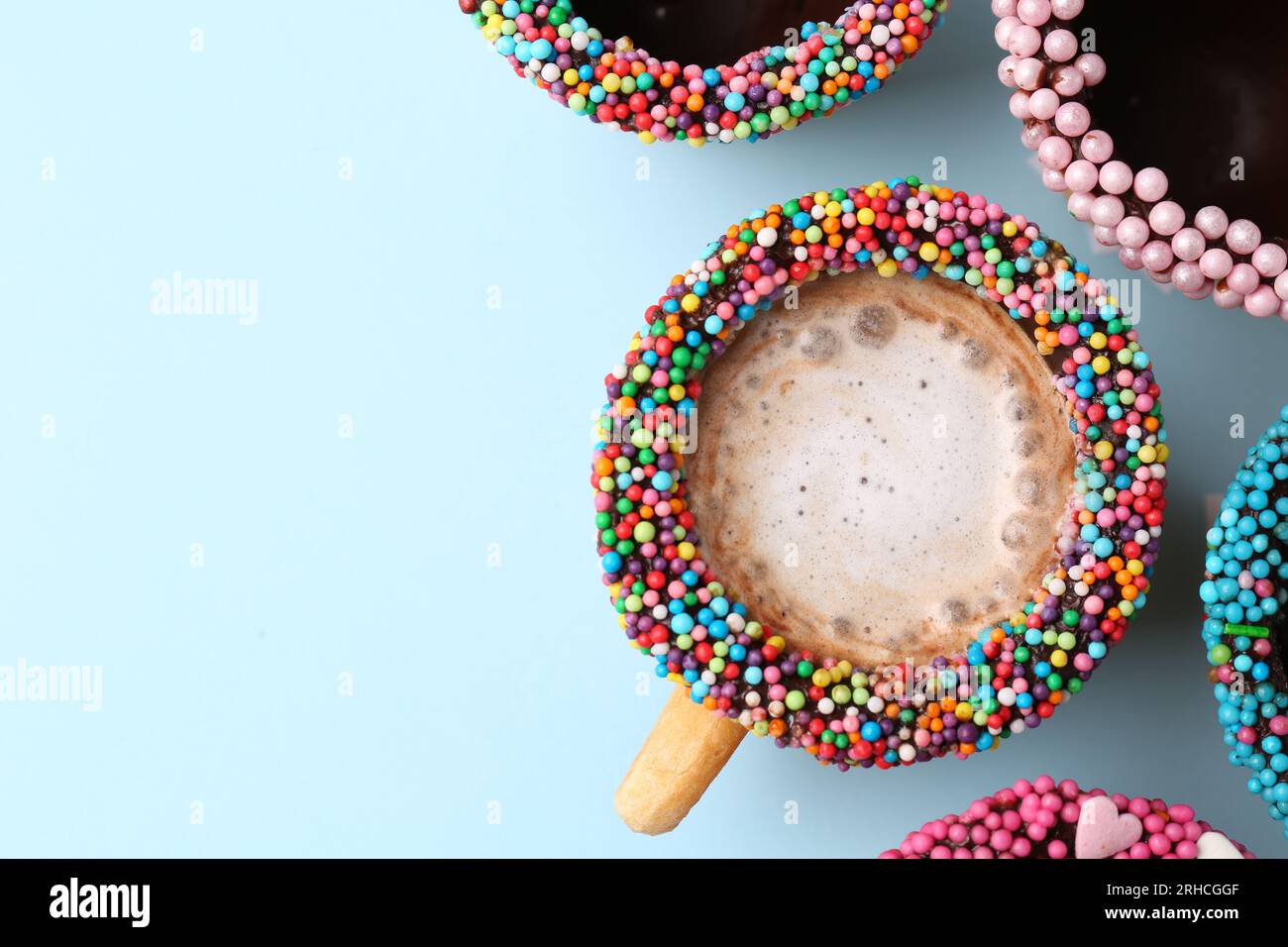 Many delicious edible biscuit cups on light blue background, flat lay ...