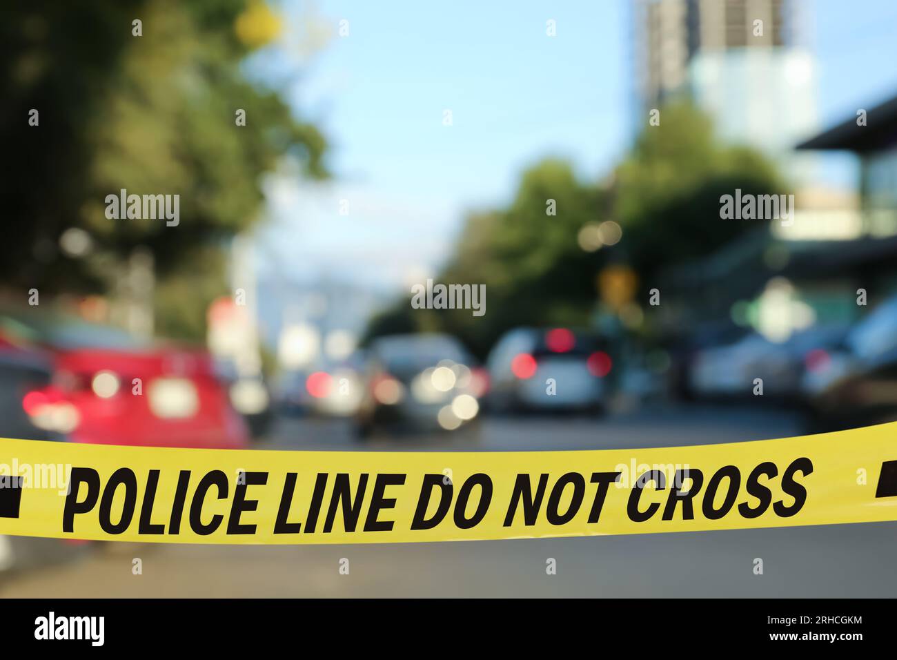 Yellow crime scene tape blocking way on street Stock Photo - Alamy