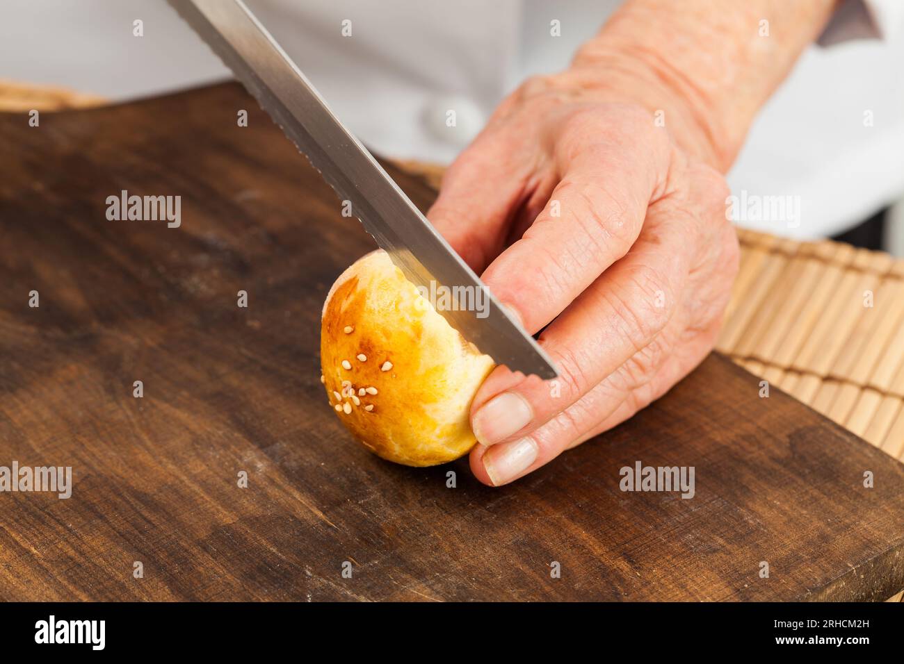 Cutting small bread buns for mini burgers. Step by step preparation of ...