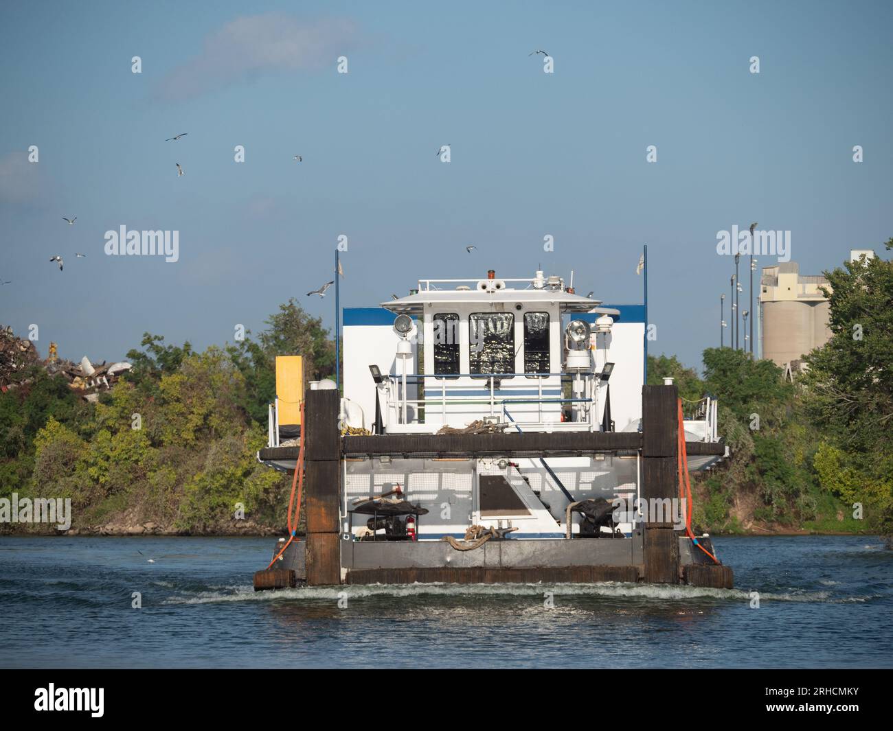 Pusher boat or tugboat on Buffalo Bayou in Houston, Texas, with a heap ...