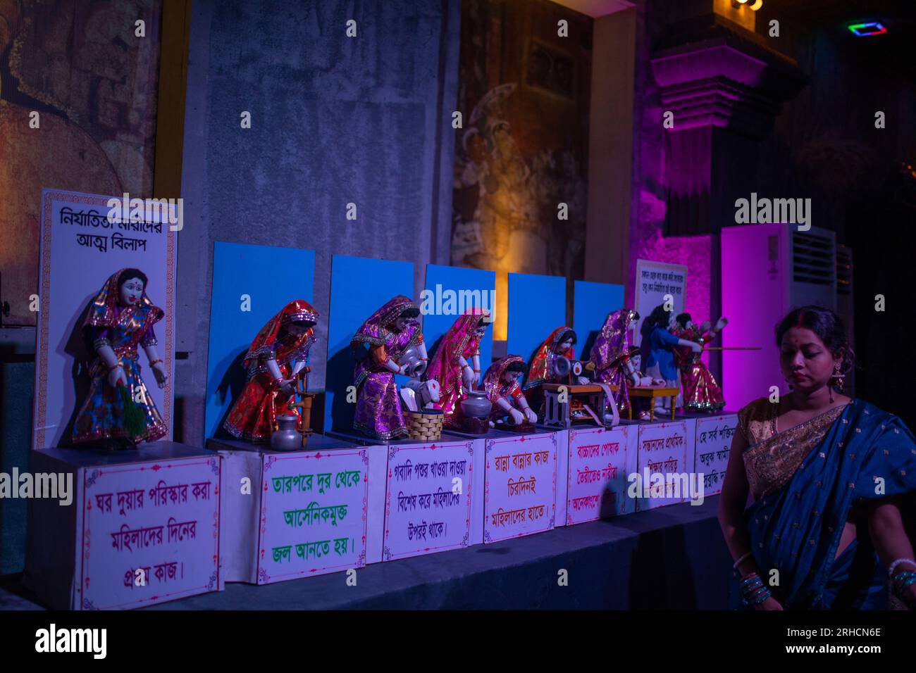 A woman walks past a display that exhibited the traditional daily ...