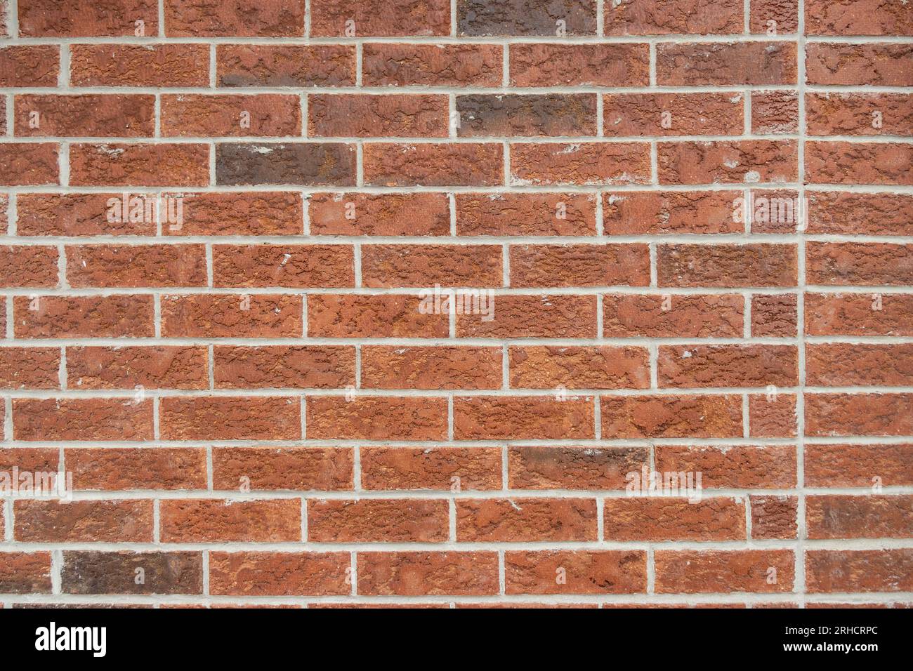 Red and brown bricks in horizontal pattern - close-up of wall - different sizes and shapes of ...