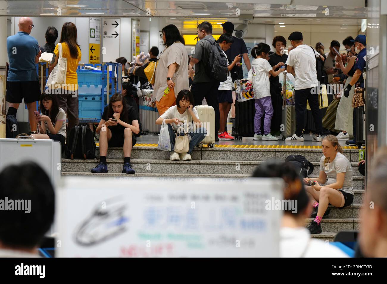 Passengers wait for the resumption of operation of Shinkansen Bullet Train at JR Tokyo Station ...