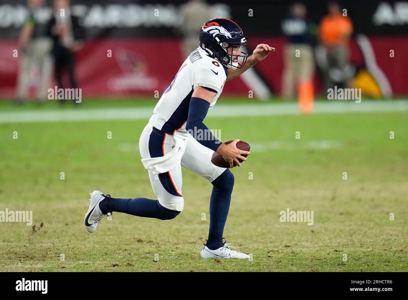 Denver Broncos quarterback Ben DiNucci scrambles with the ball against ...