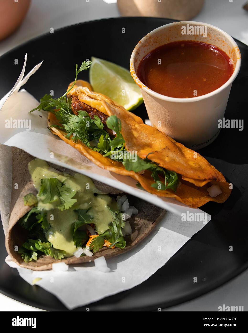barbecue tacos, with its consomme on the side, mexican tacos in black ...
