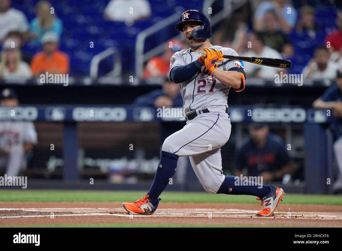 Houston Astros' Jose Altuve reacts after hurting himself while batting ...