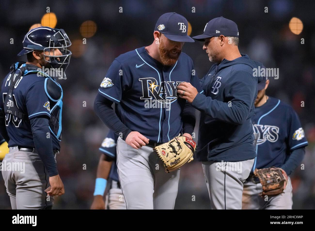 Tampa Bay Rays pitcher Zack Littell, middle, walks off the mound after ...