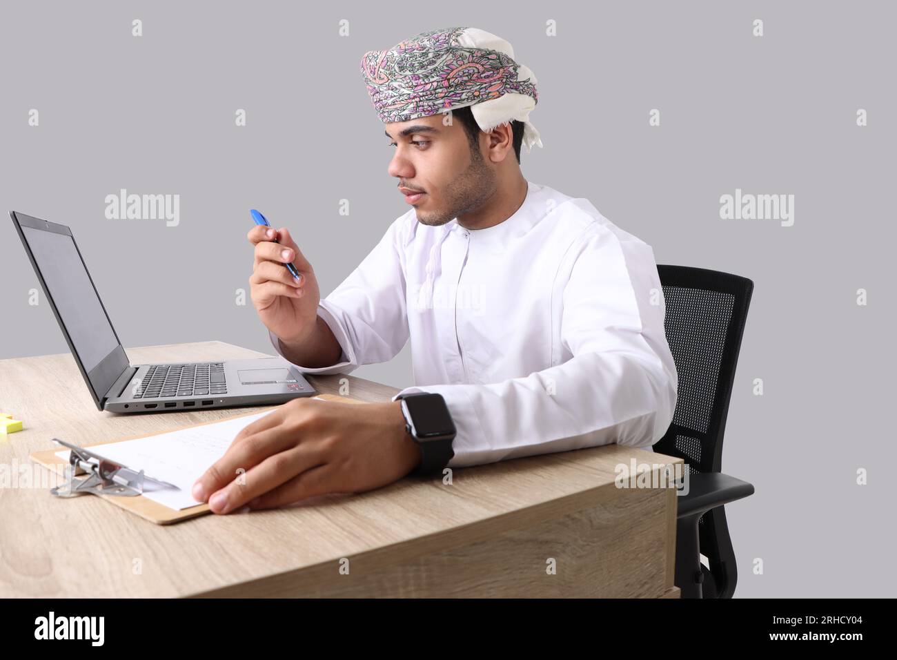Omani Man working in office Stock Photo - Alamy