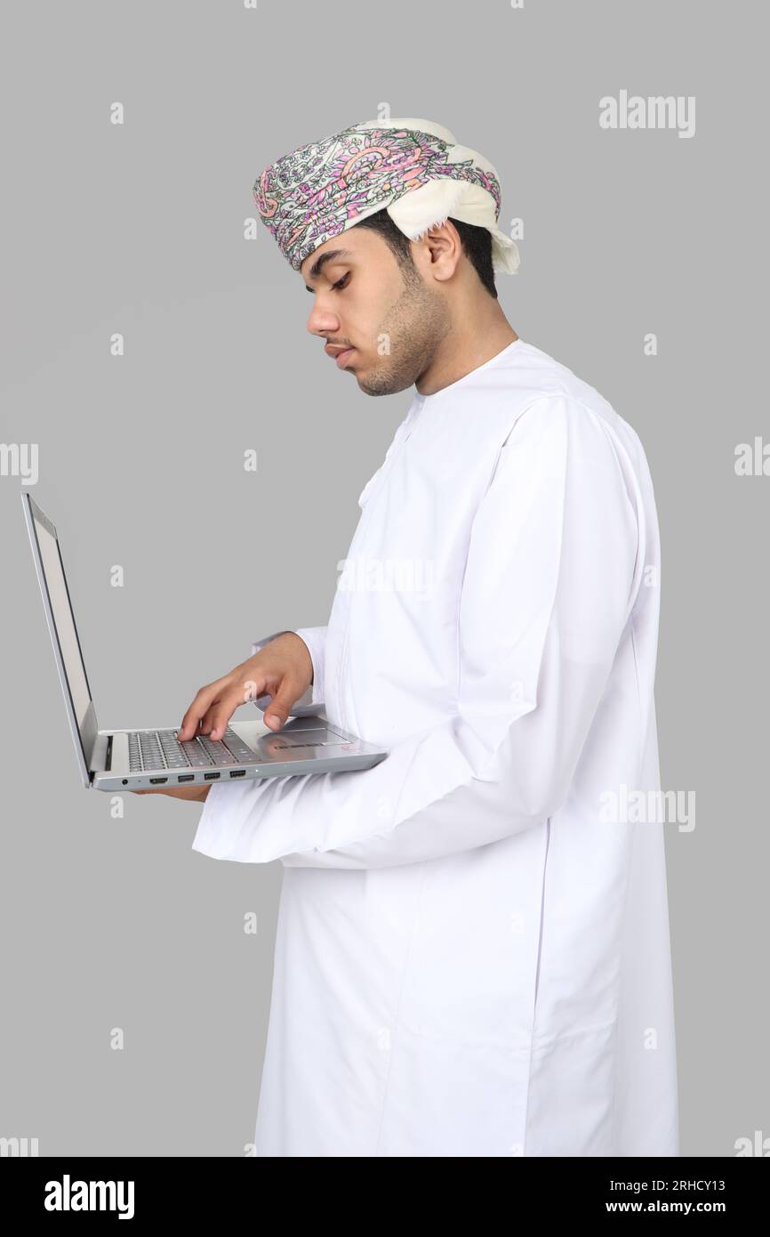 Omani Man holding laptop Stock Photo - Alamy