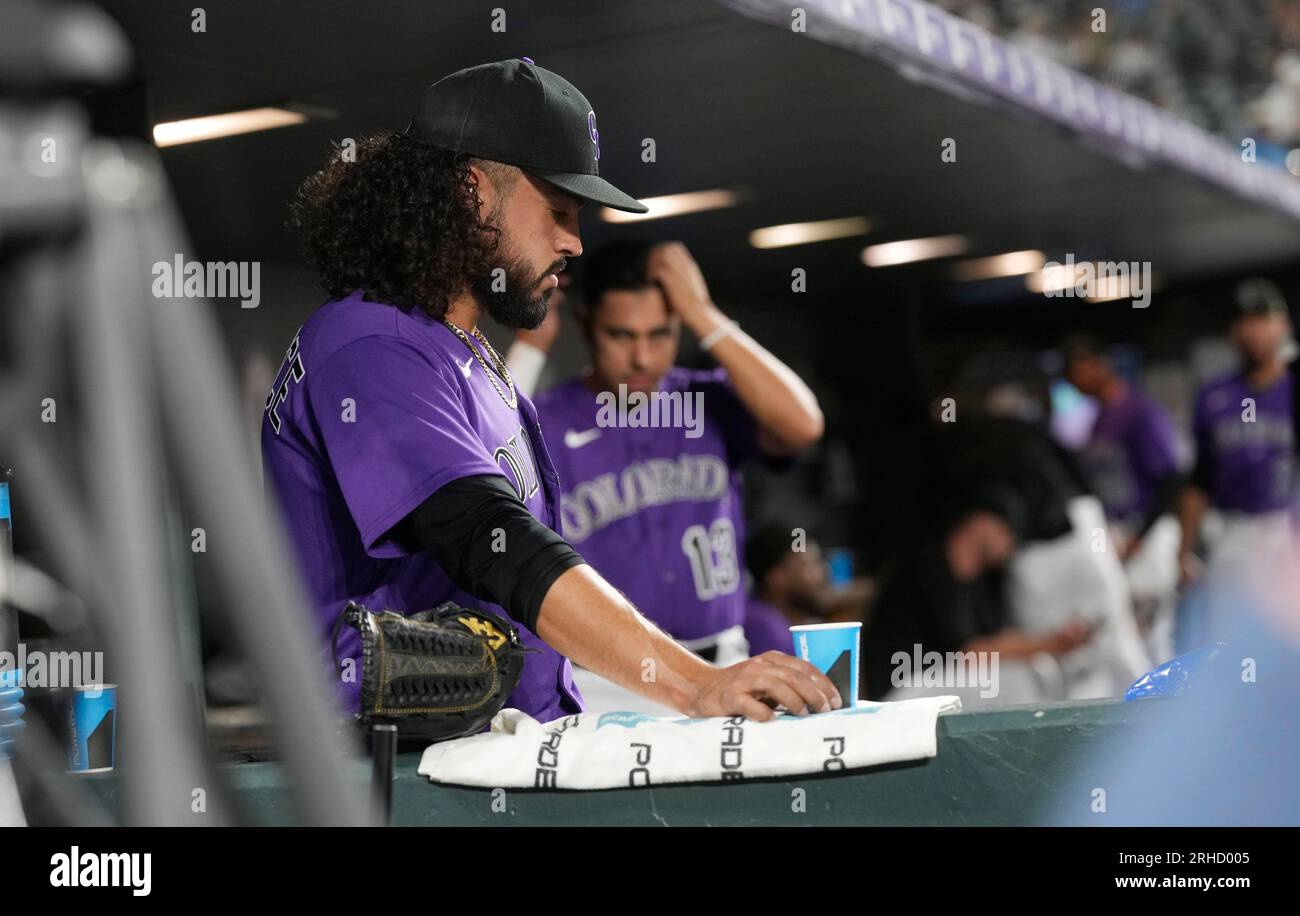 Colorado Rockies relief pitcher Justin Lawrence stands in the dugout ...