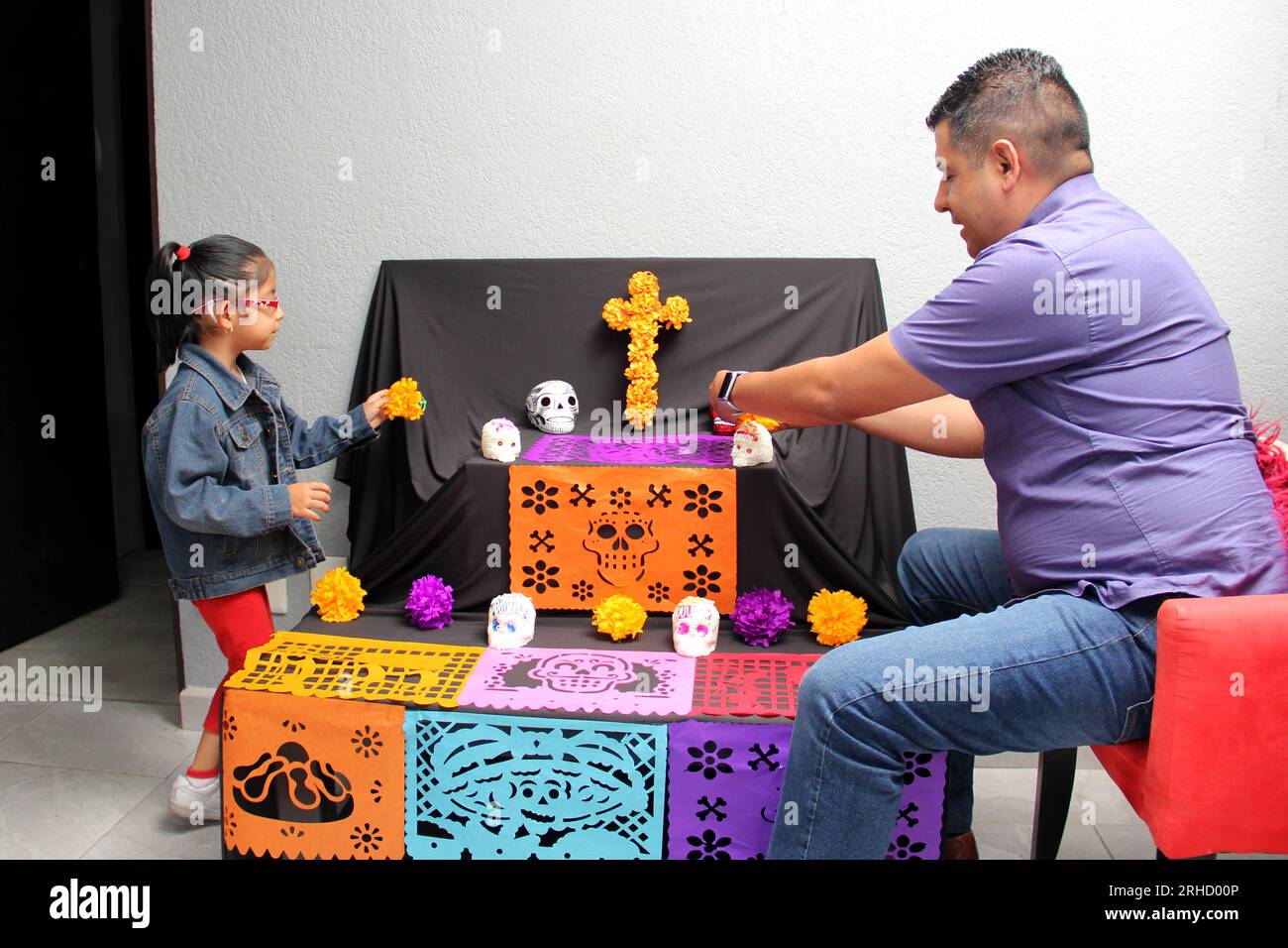 Mexican dad and daughter put the altar and offering of the Day of the ...
