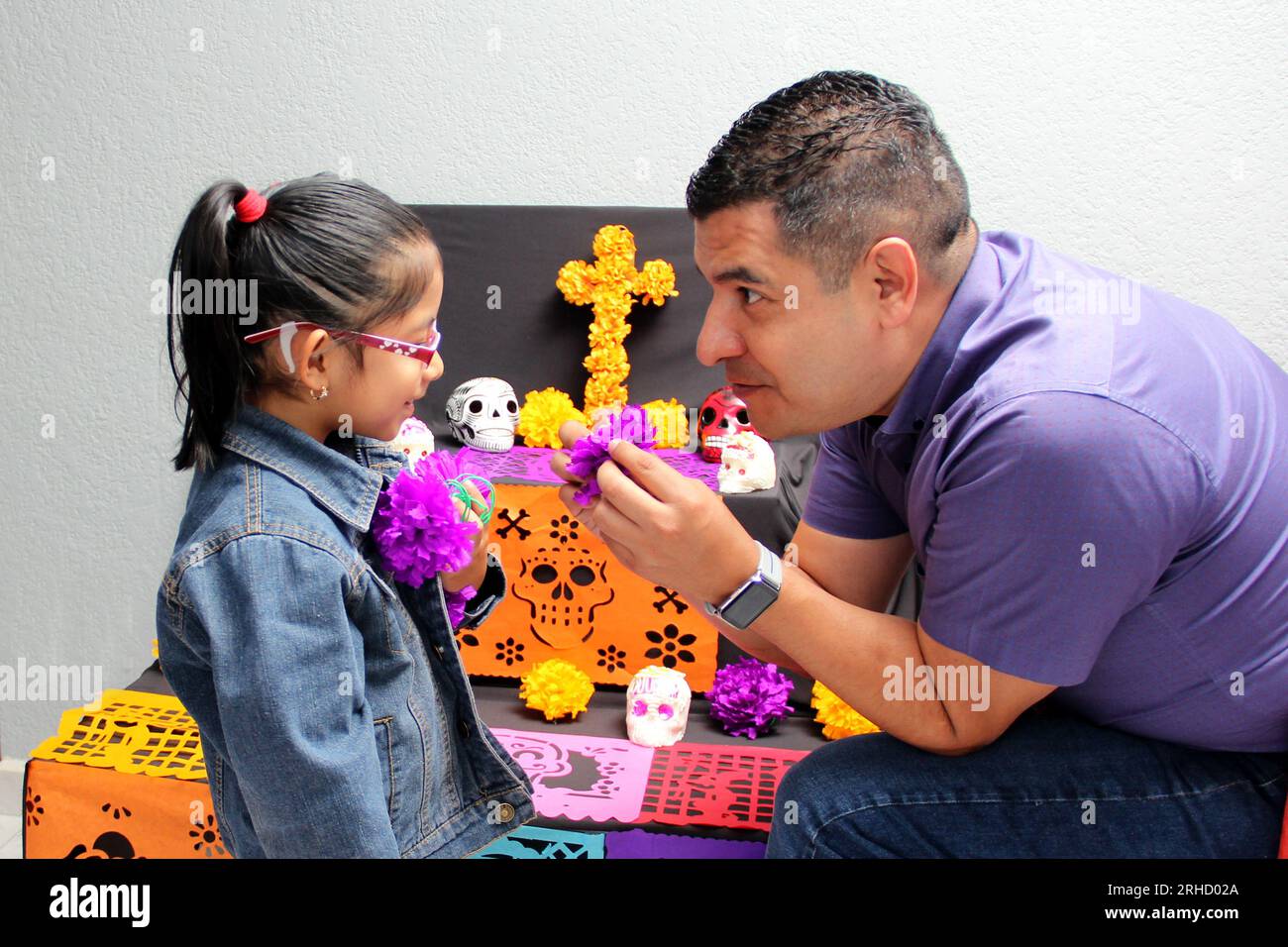 Mexican dad and daughter put the altar and offering of the Day of the ...