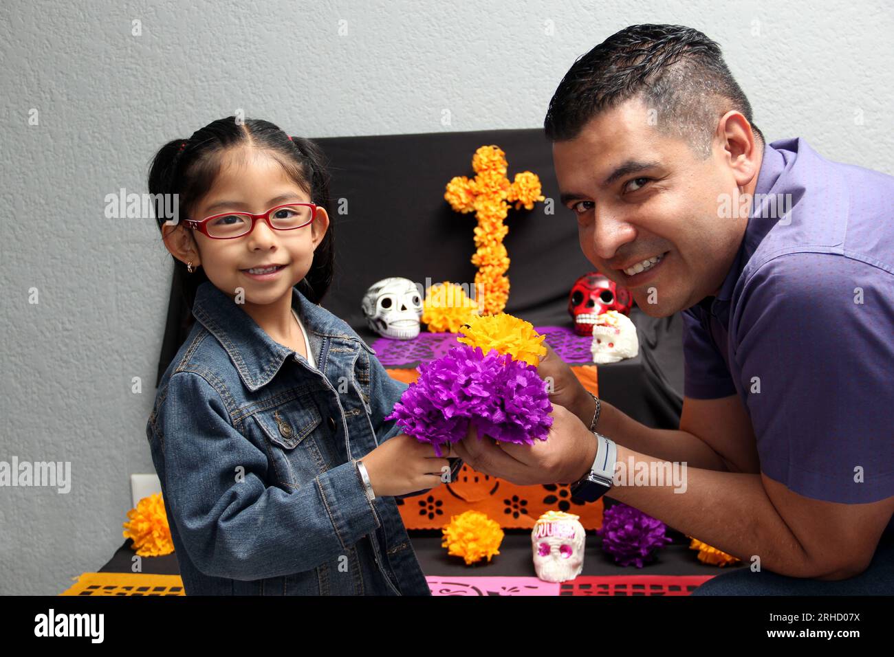 Mexican dad and daughter put the altar and offering of the Day of the ...