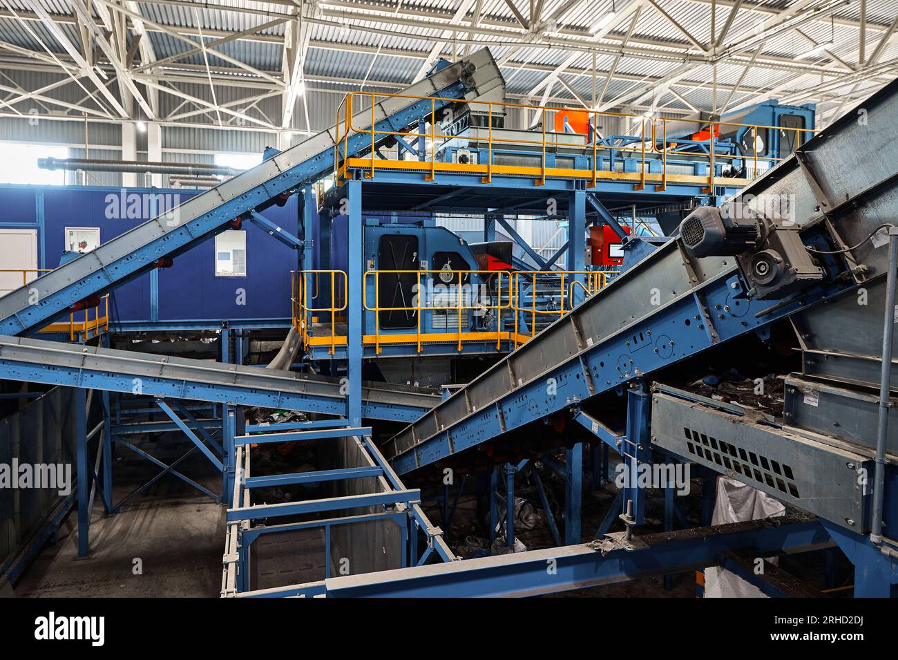 Conveyors carry trash and empty platforms at recycling plant Stock ...