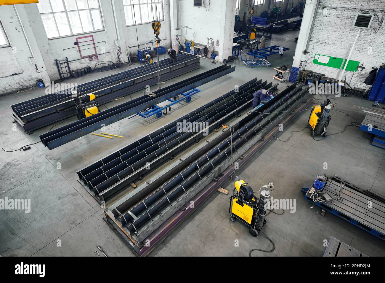 Long steel constructions assembling with welding in workshop Stock ...
