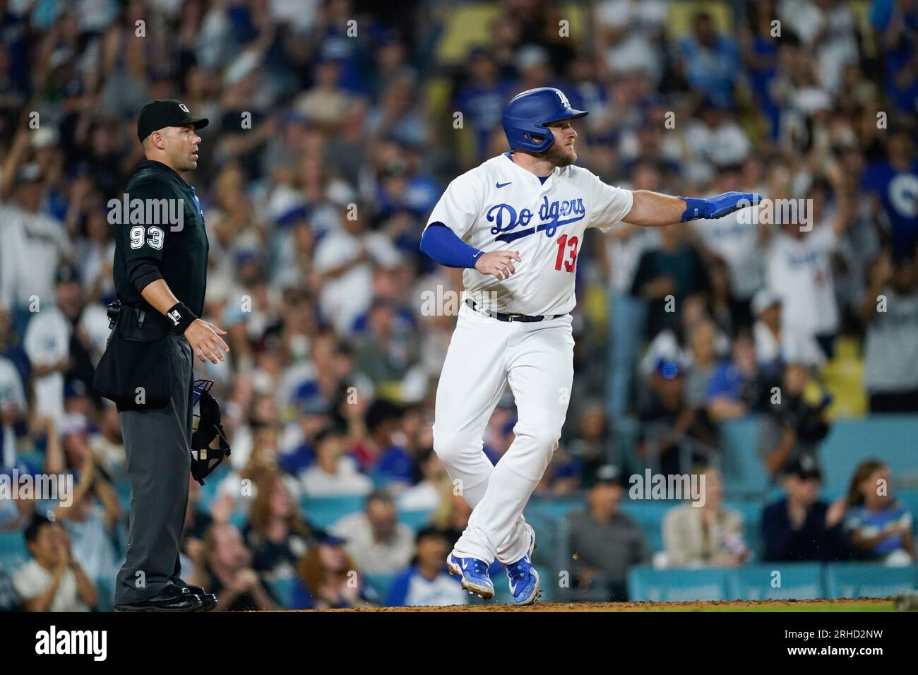 Los Angeles Dodgers' Max Muncy turns to watch after scoring on a single ...