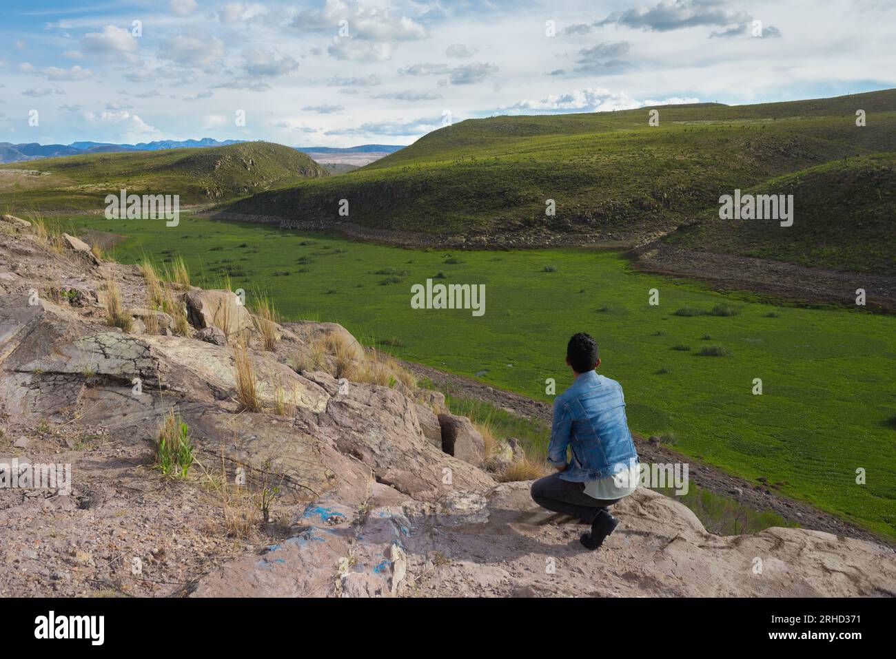 Mexican man observes the natural horizon of green forests from the top ...