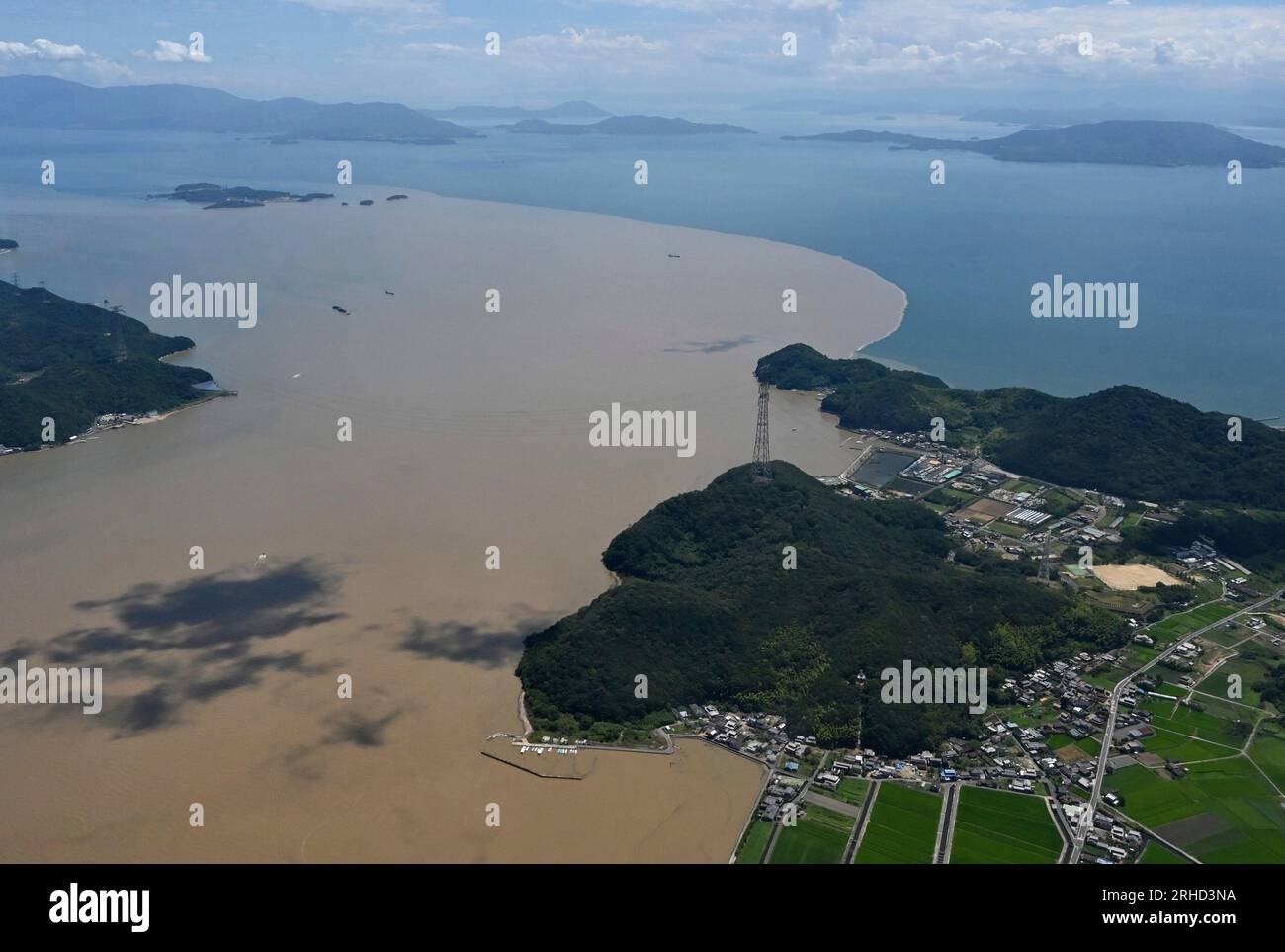 An aerial photo shows brown muddy water flowing in the Seto Inland Sea ...