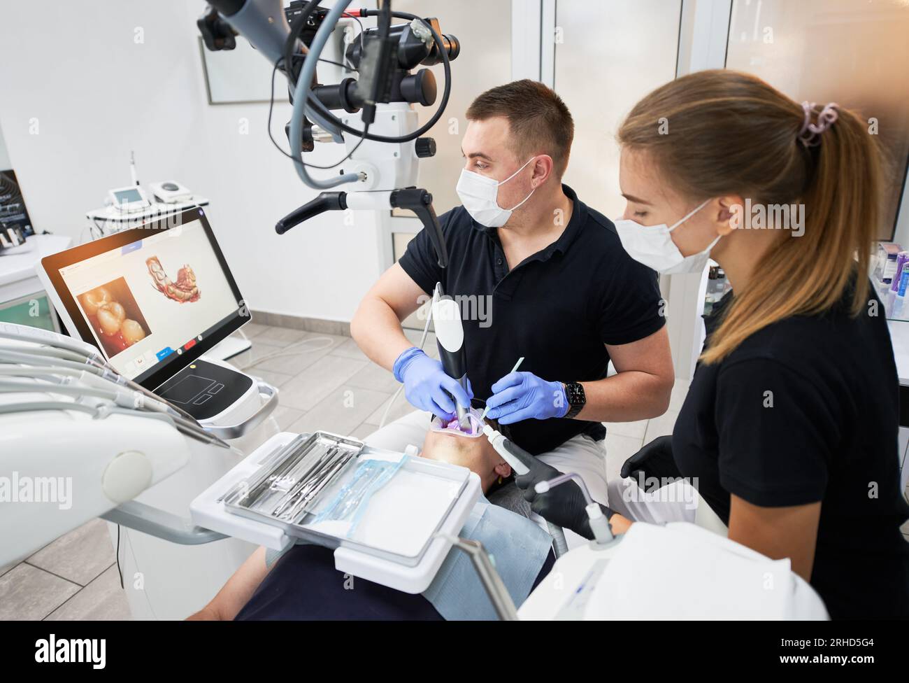 Dentist scanning patient's teeth with modern machine for intraoral ...