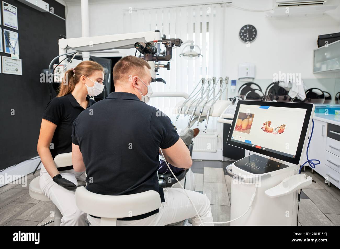 Dentist scanning patient's teeth with modern machine for intraoral ...
