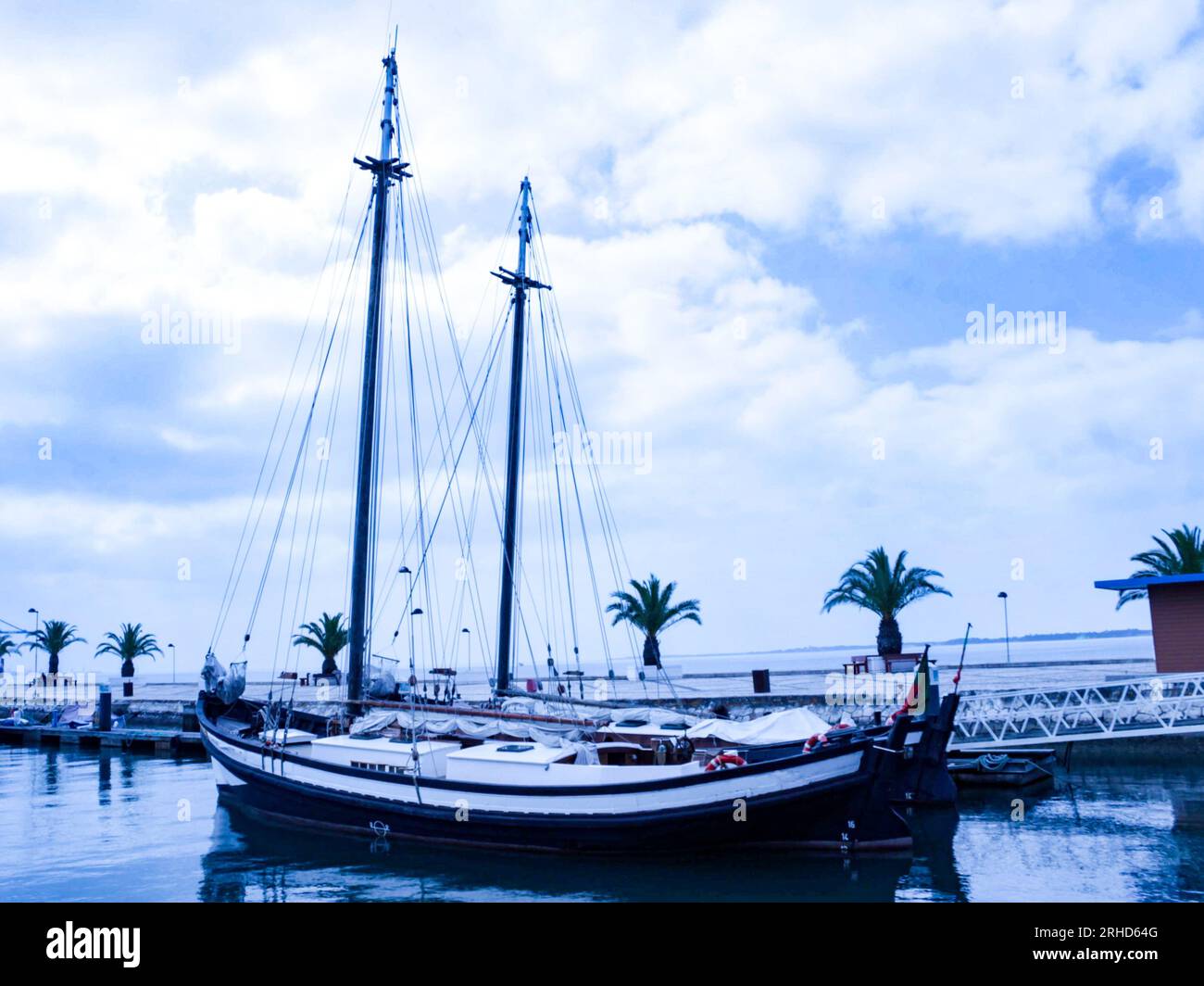 A traditional Portuguese sailing boat anchored in the marina Stock ...