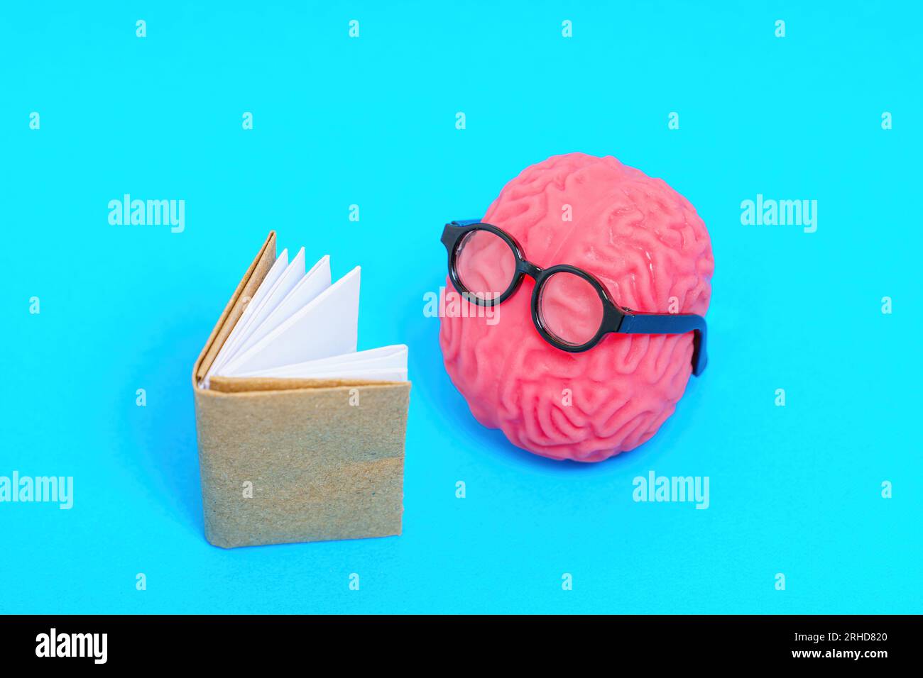 Cute human brain character adorned with glasses, deeply engrossed in ...