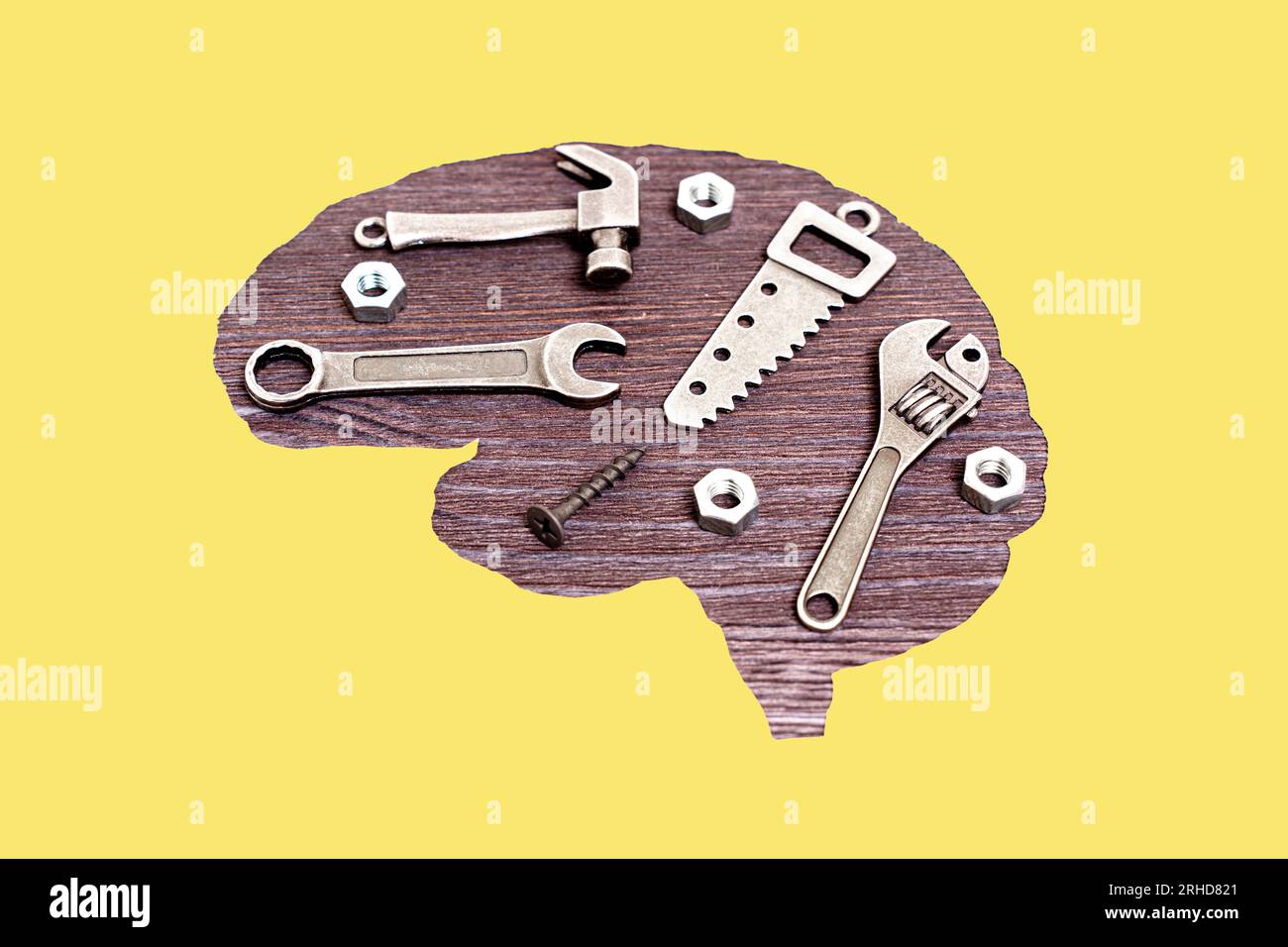Brain-shaped paper cutout showing miniature replicas of essential hand ...