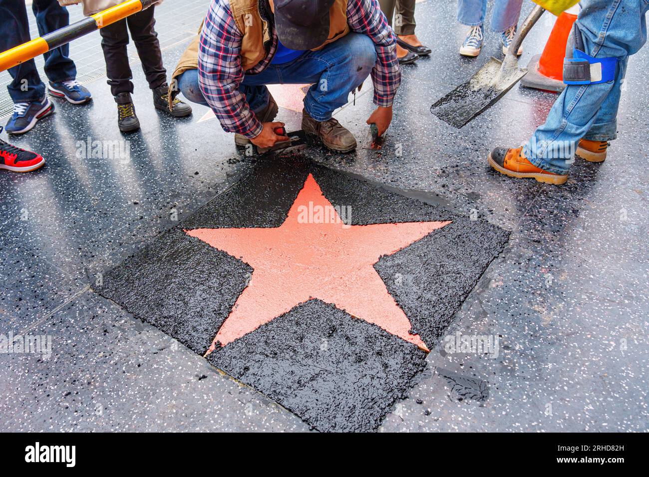 Group of tourists observing the installation of a new star on the ...