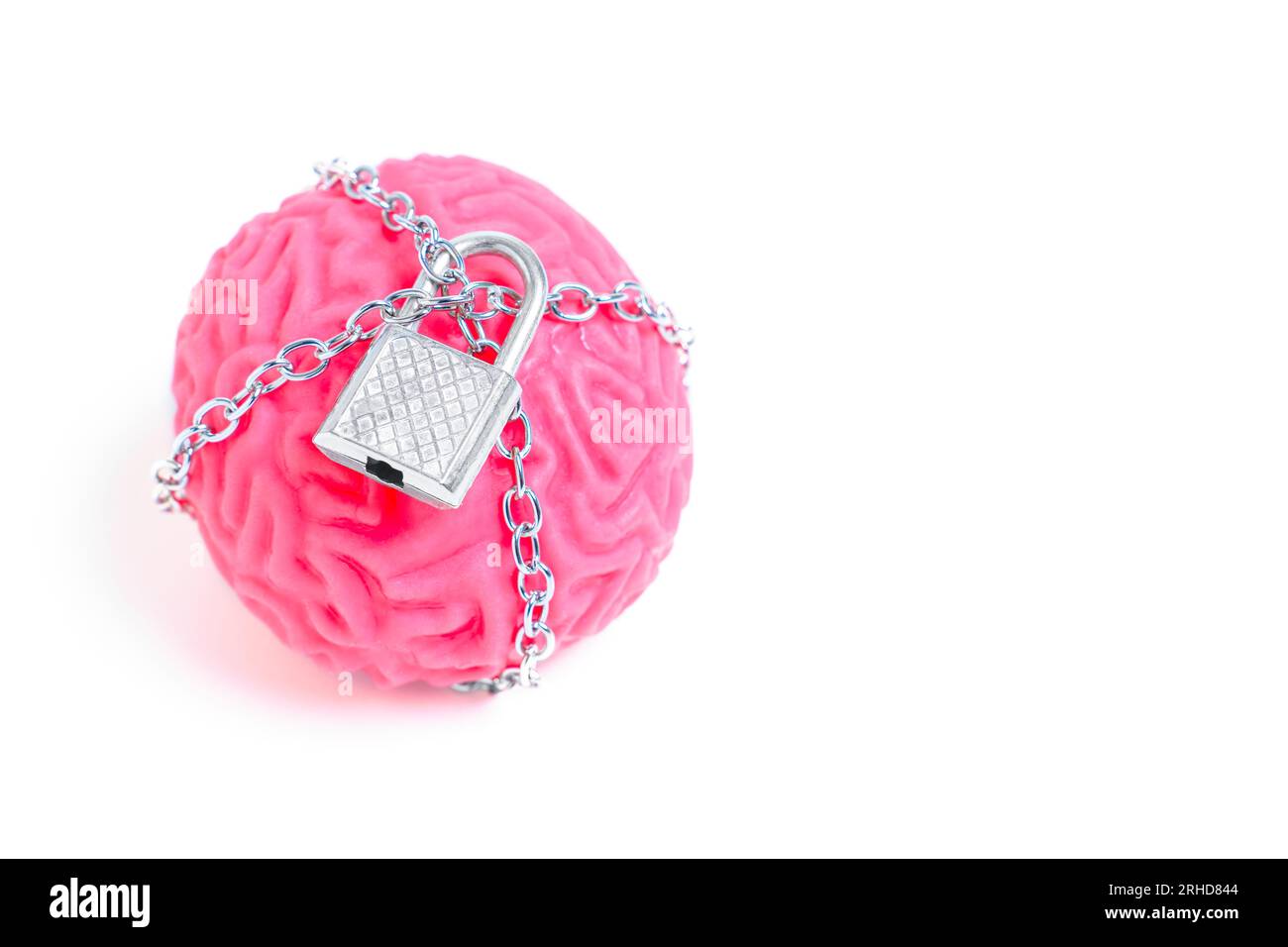 Close-up of a human brain replica confined by chains and secured with a ...