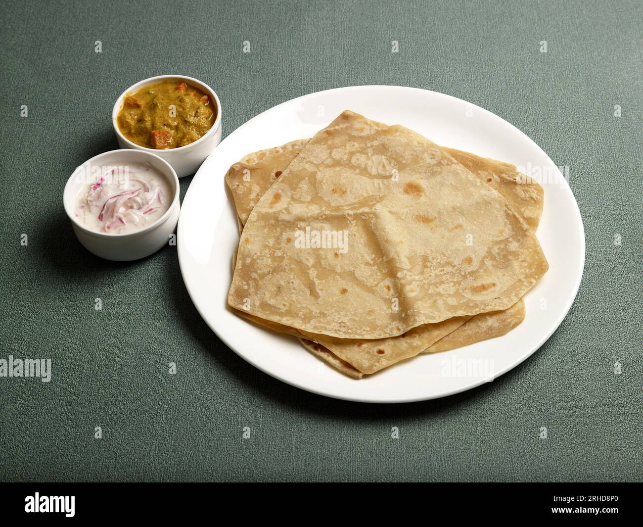 Chapati with korma and raita served in a plate Stock Photo - Alamy