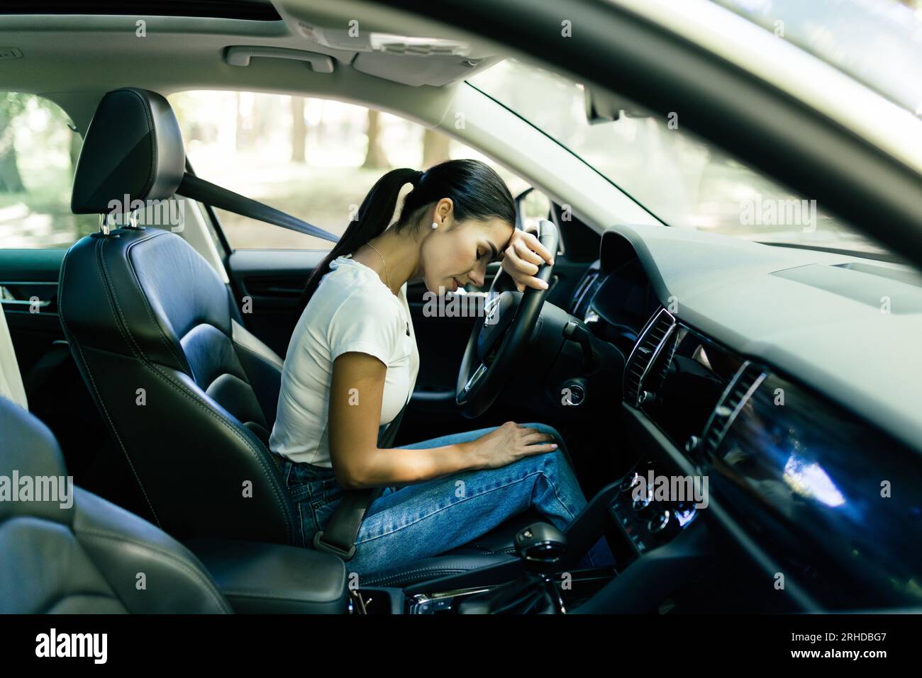 Tired young woman car driver suffering from headache migraine driving ...