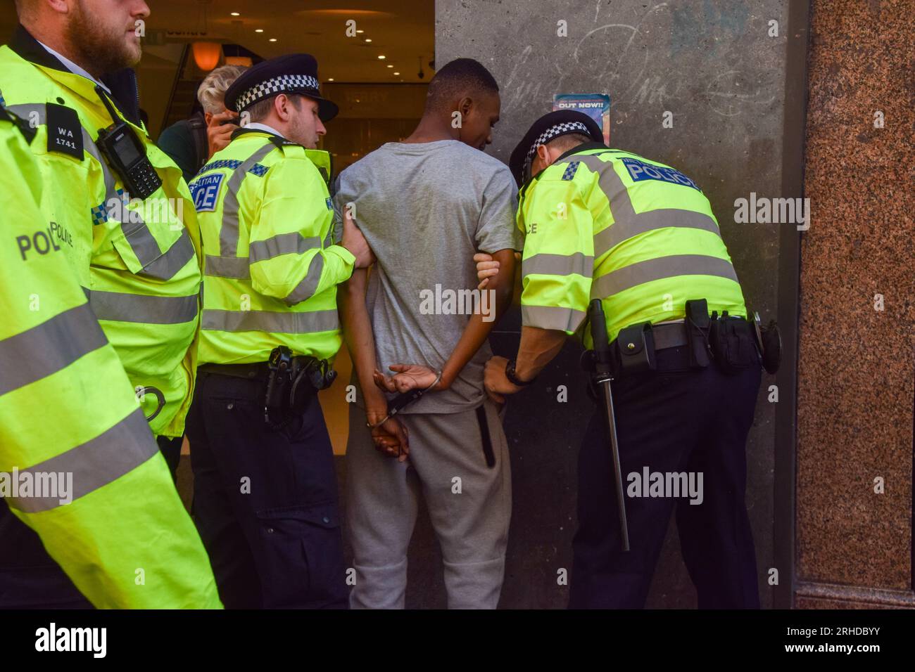 London, UK. 9th August 2023. Police officers detain a young man on ...