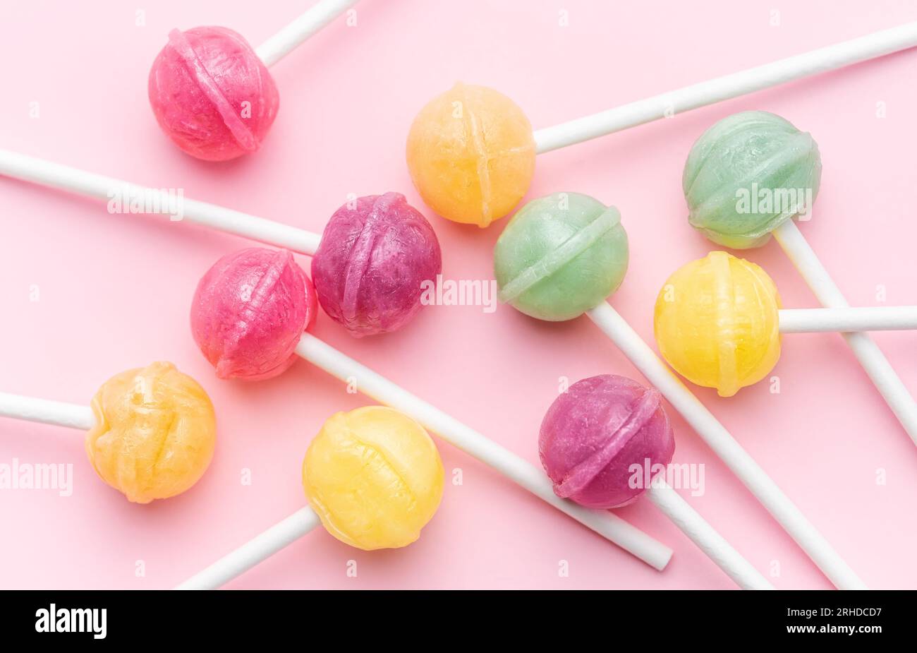 Colorful sweet lollipops over pink background. Flat lay, top view Stock ...