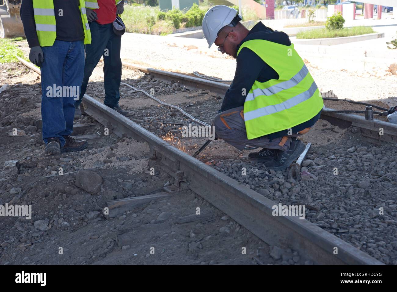 Construction workers using an oxy acetylene cutting torch to remove old ...