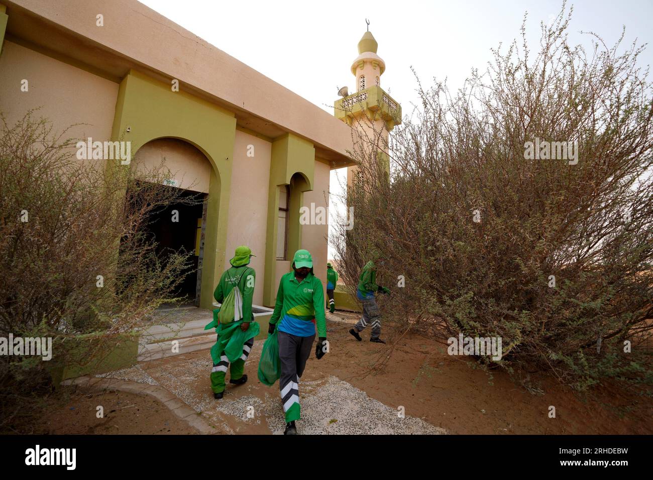 Labourers clean a mosque at the Ghost Village in Al Madam area, 100 km ...