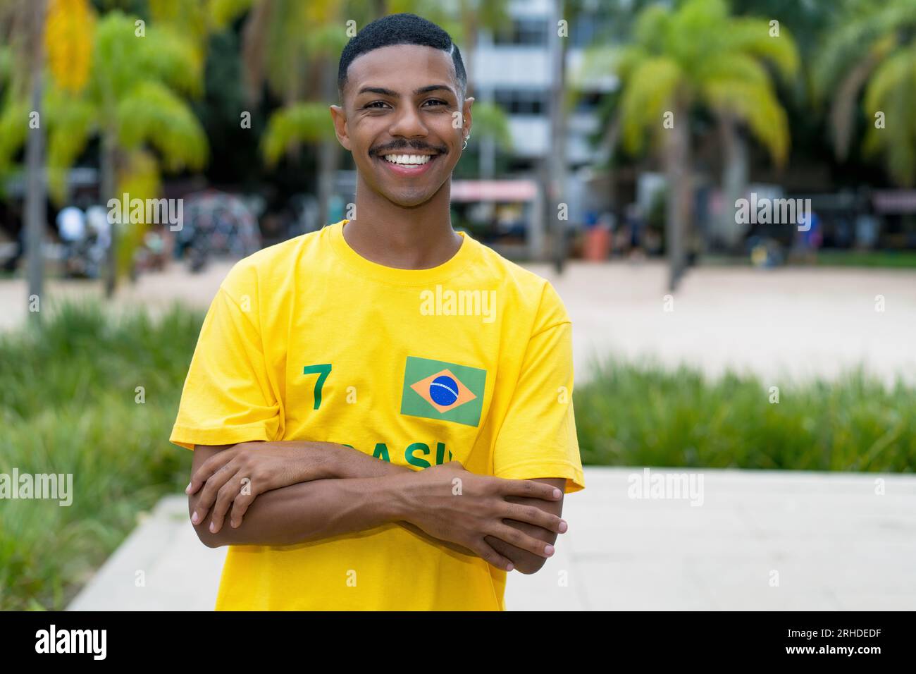 Handsome young man from Brazil with yellow football jersey outdoor at ...
