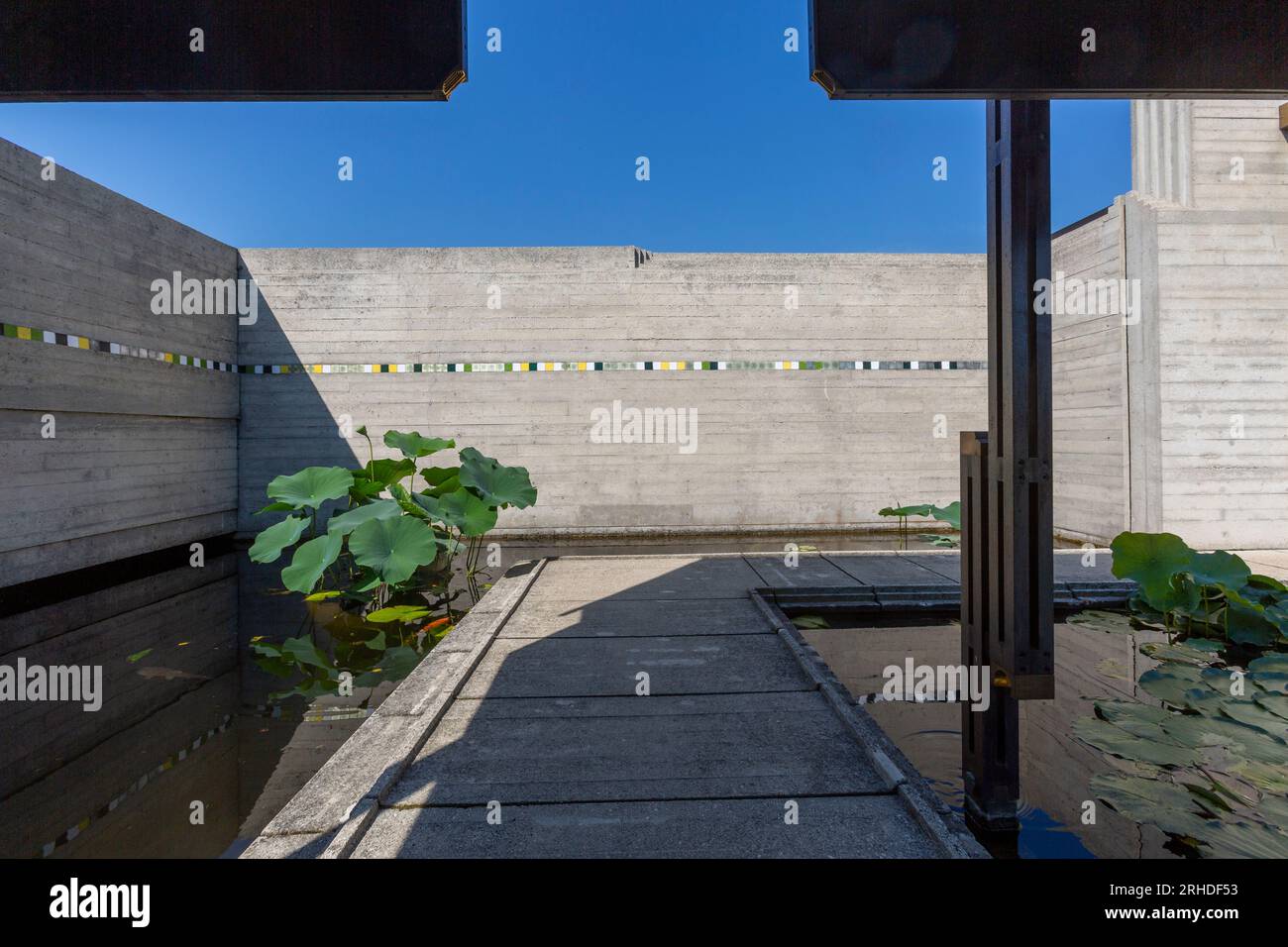 The meditation pavilion, surrounded by pools with plants and water ...