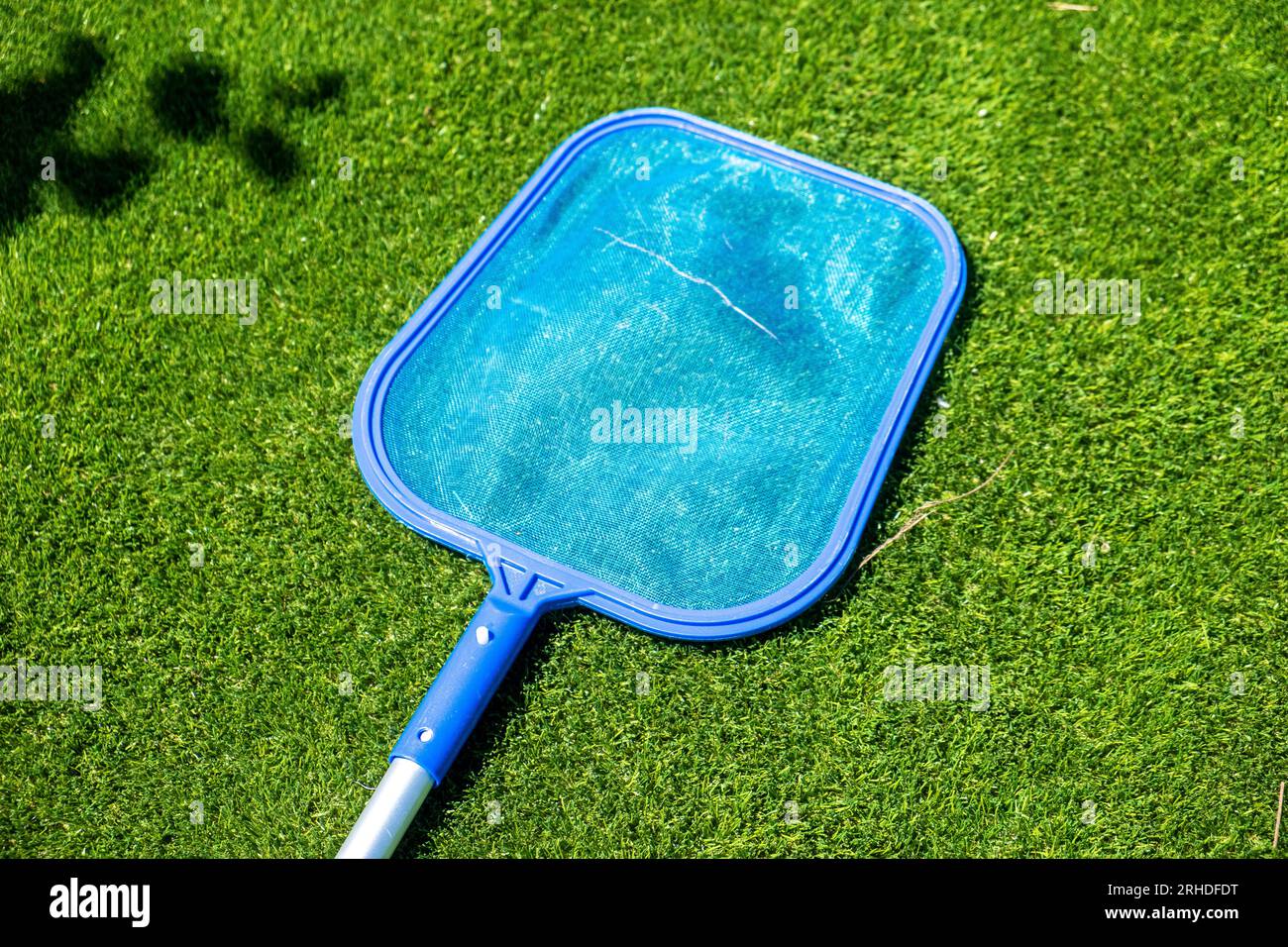 detail of a swimming pool cleaning net, summer time Stock Photo - Alamy