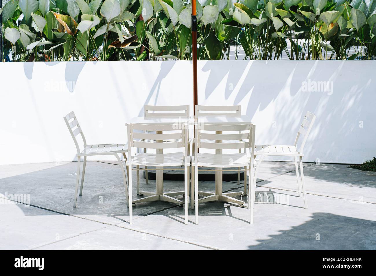 Outdoor table, chair and a umbrella in a tropical cafe. There are many ...