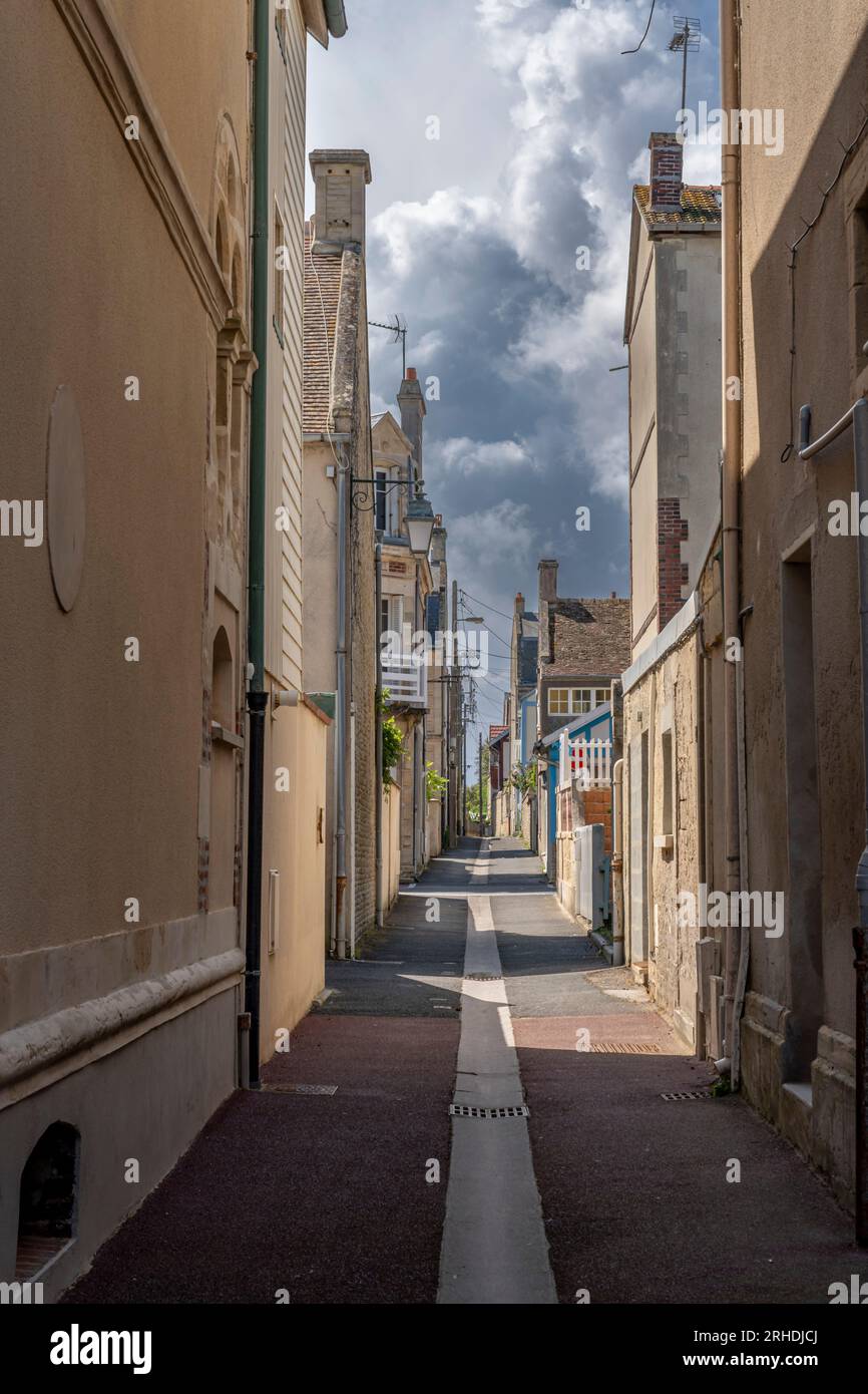 View from a tiny street of the beach, the sea and houses Stock Photo ...