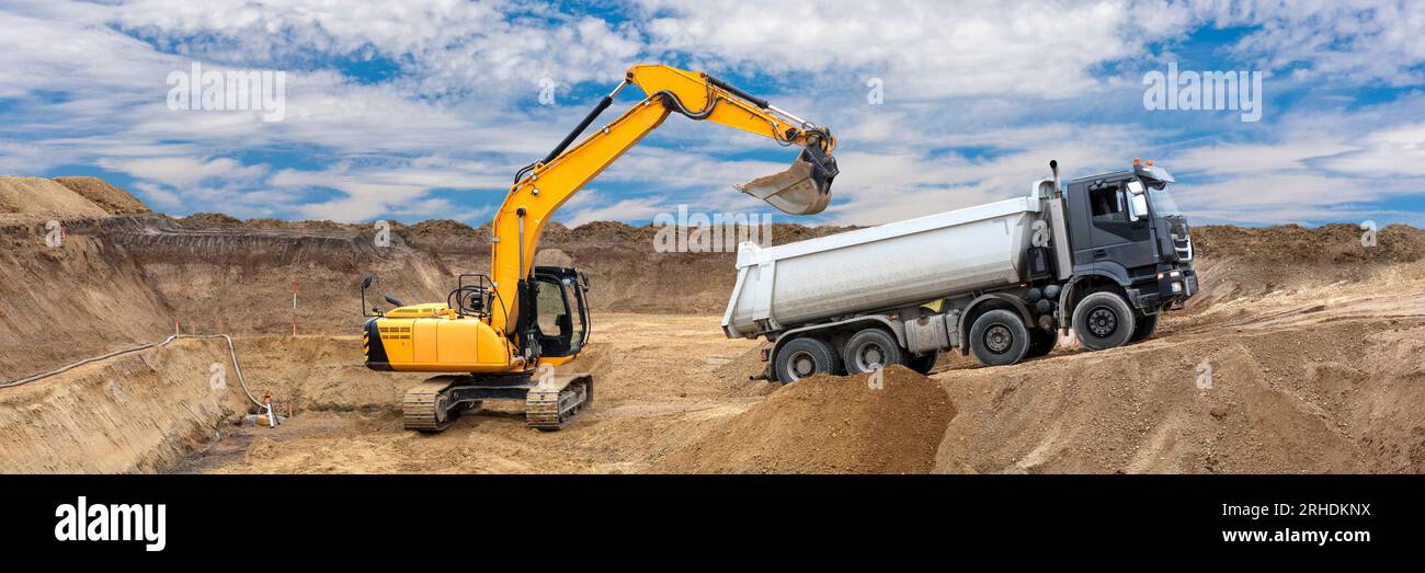 excavator is in work and digging at construction site Stock Photo - Alamy