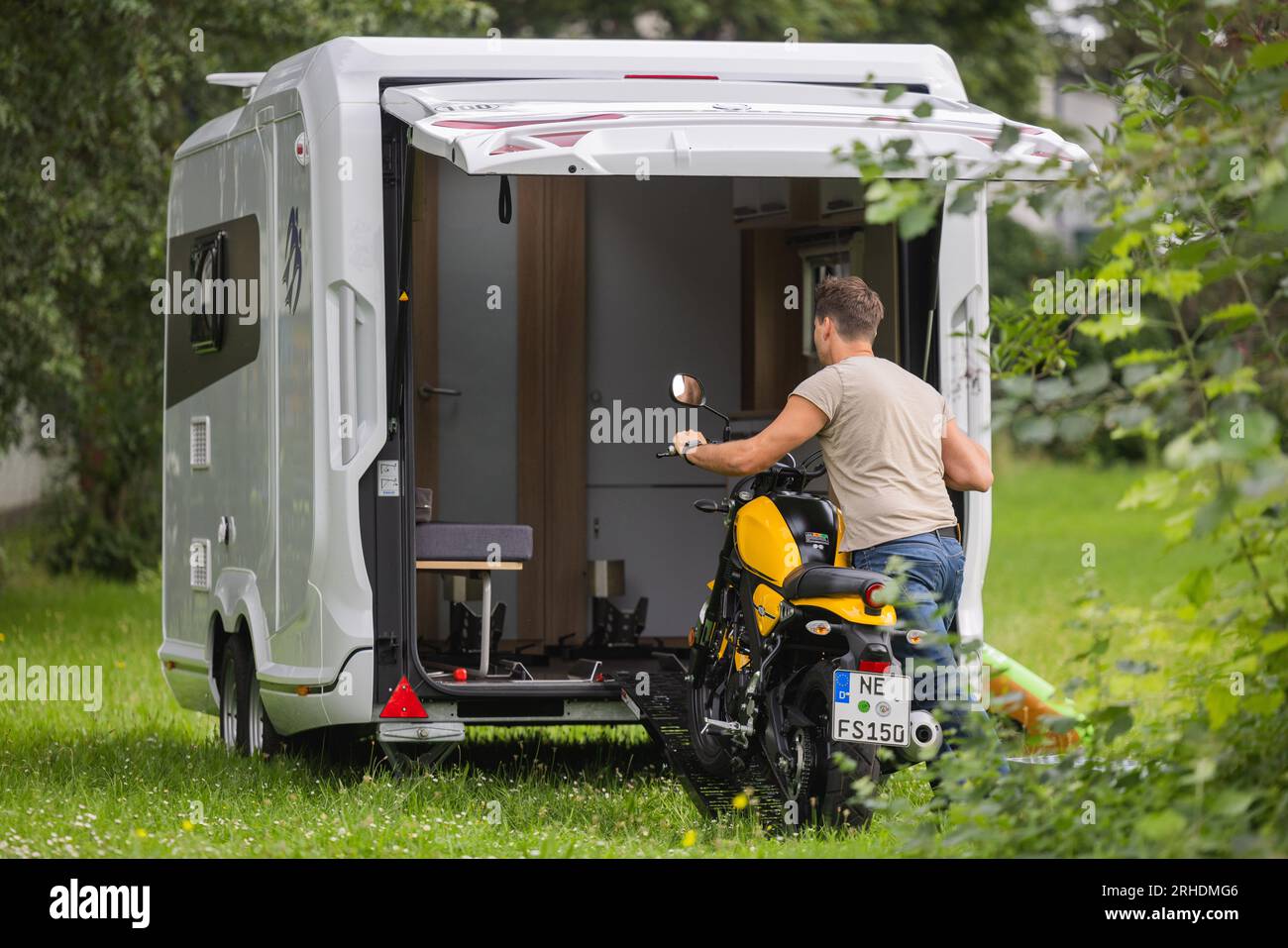 Duisburg, Germany. 16th Aug, 2023. Model Ralf pushes a motorcycle into ...
